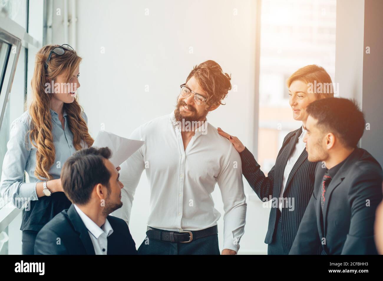 Colleagues giving an applause to a meeting leader while he is making a ...