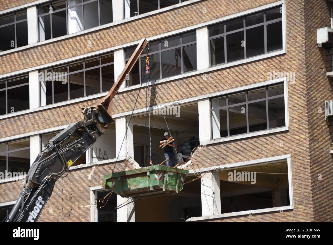 Demolition of old brick building with help of high reach excavators ...