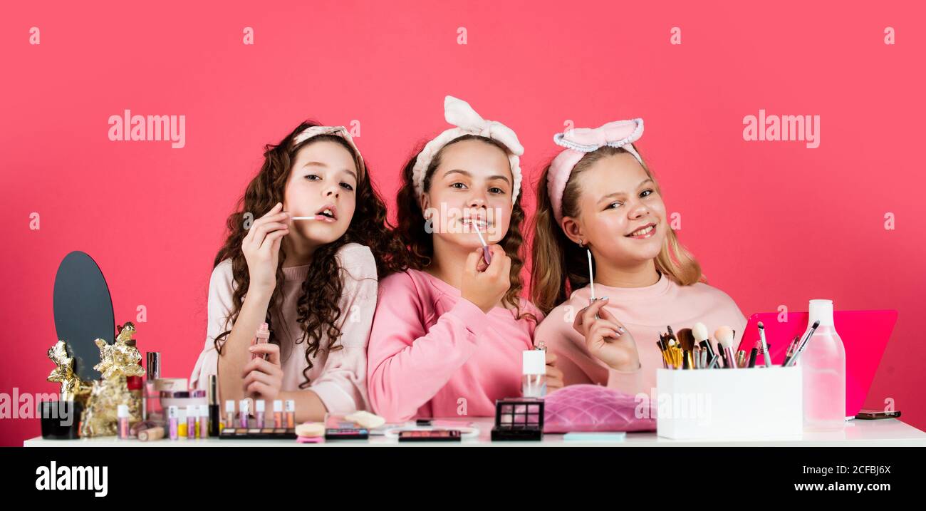 Cosmetics shop. Happy girls doing makeup. Sisters play with cosmetics ...