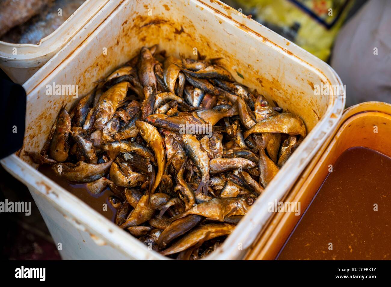 bucket of preserved fish at a market Stock Photo - Alamy