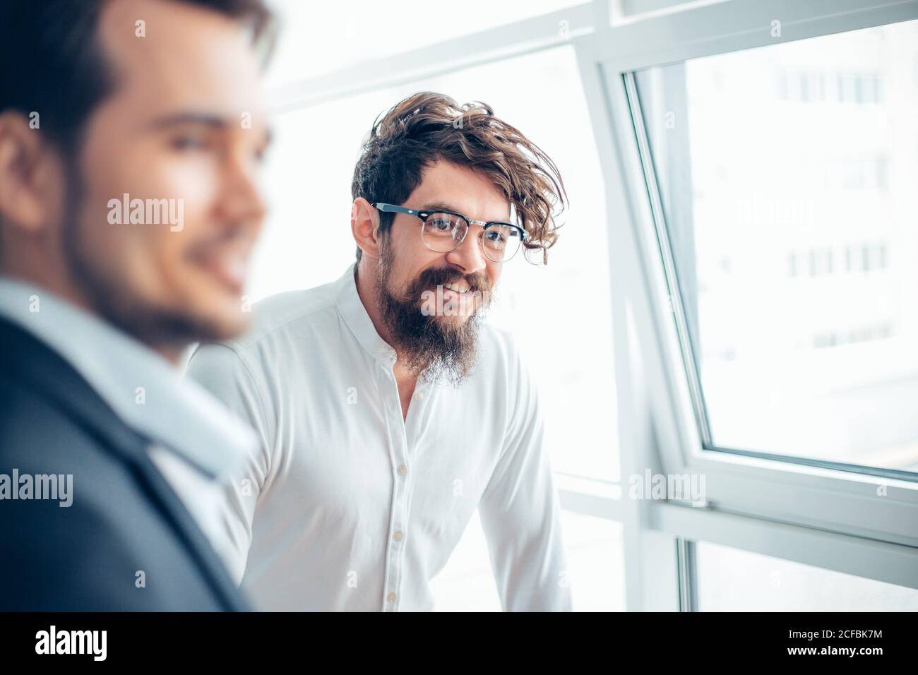 Confident businessman. Young handsome man holding notepad and looking ...
