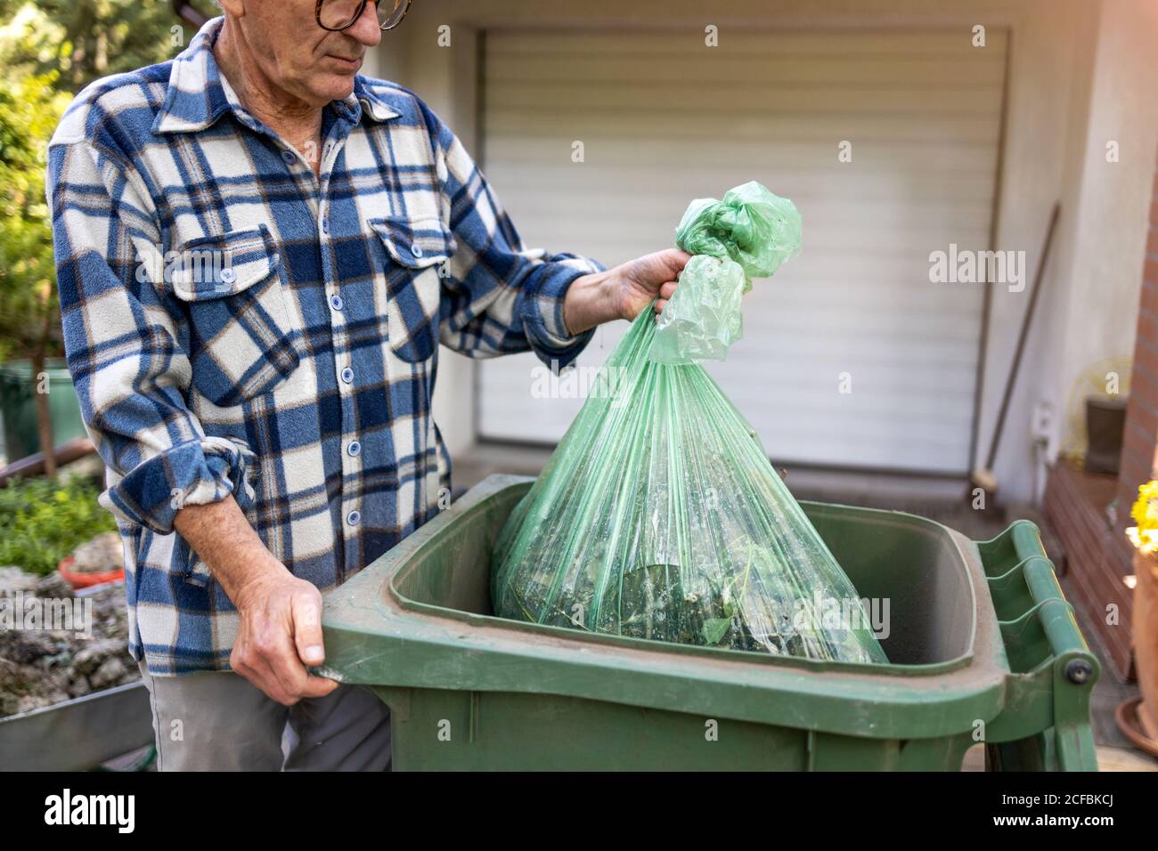Man rolling garbage hi-res stock photography and images - Alamy