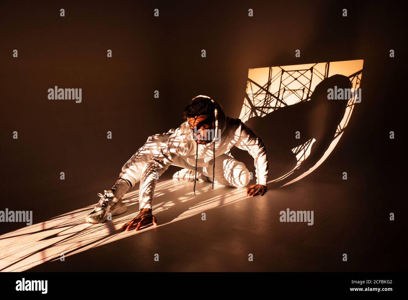 Black man dancing under bright light Stock Photo - Alamy