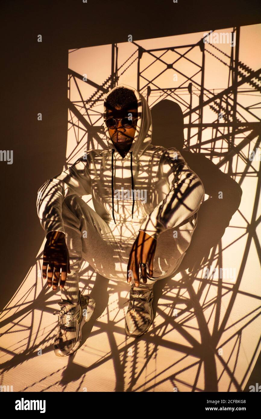 Black man dancing under bright light Stock Photo - Alamy