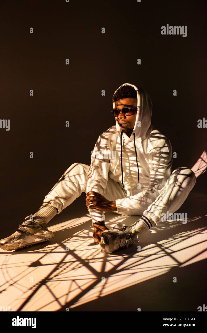 Black man dancing under bright light Stock Photo - Alamy