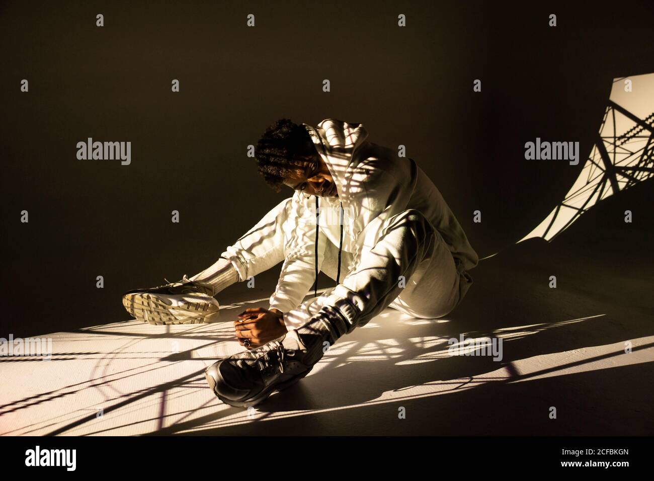 Black man dancing under bright light Stock Photo - Alamy