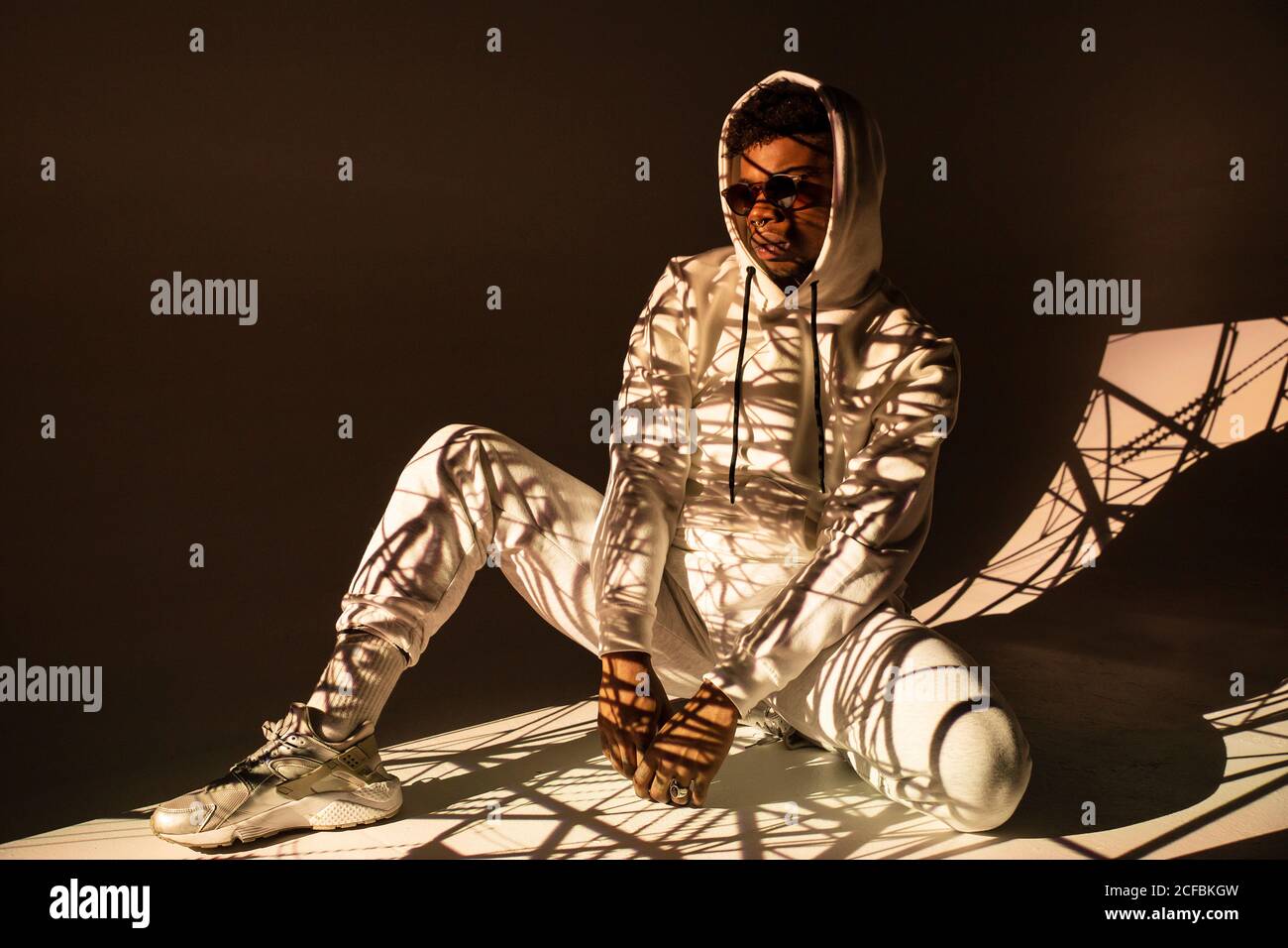 Black man dancing under bright light Stock Photo - Alamy