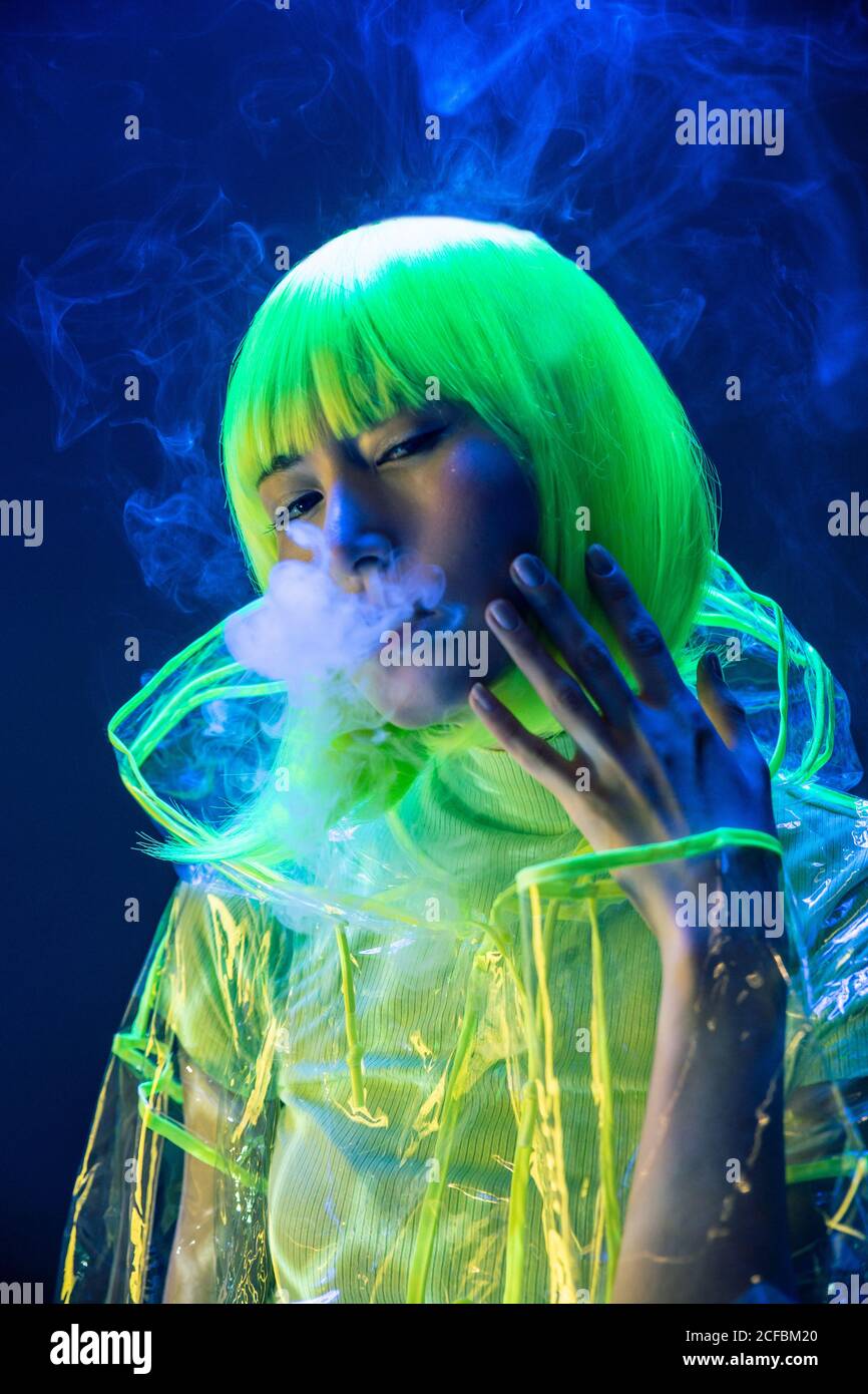 Young pretty unusual Asian Woman in plastic transparent raincoat and ...
