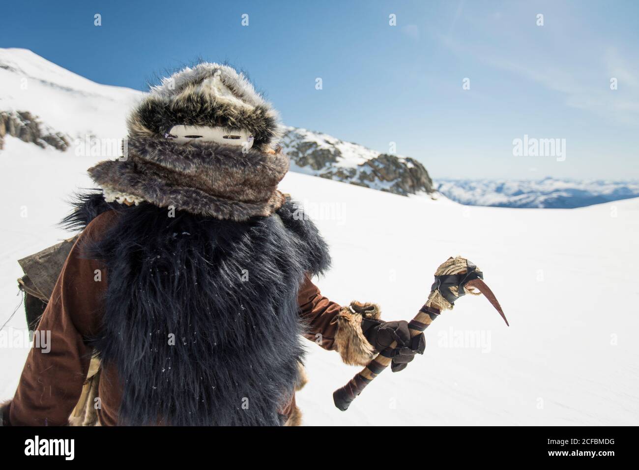 Native American hunter holds Traditional ax tool in mountains Stock ...