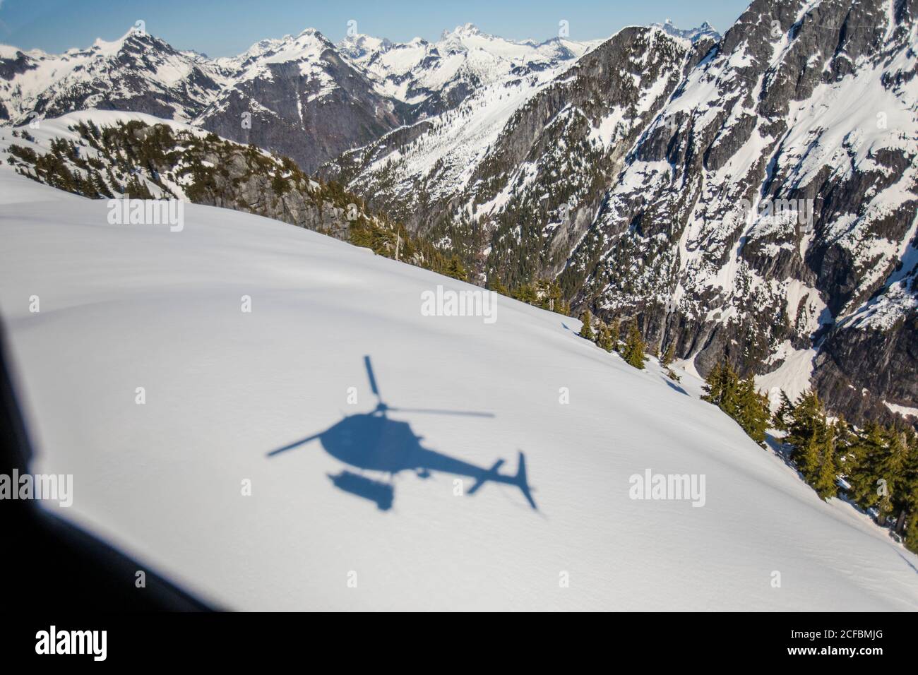 Shadow of helicopter seen on snowy mountain landscape Stock Photo - Alamy