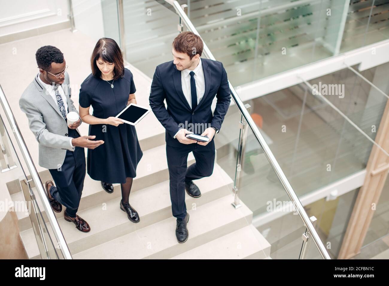 Businesswoman going down stairs hi-res stock photography and images - Alamy