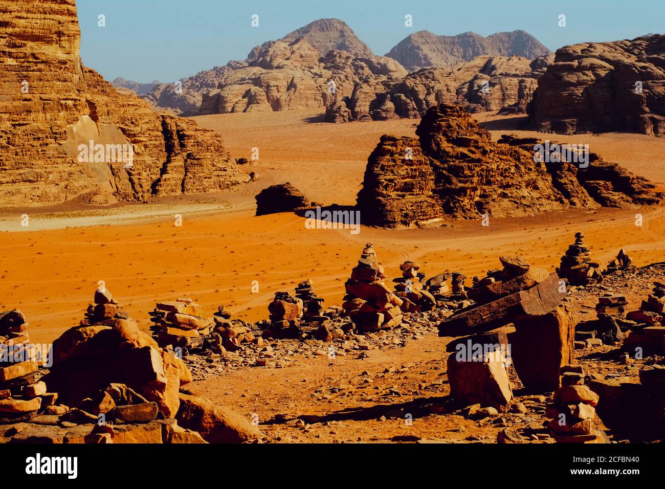 Stacked rocks left by tourists in Wadi Rum, Jordan Stock Photo - Alamy