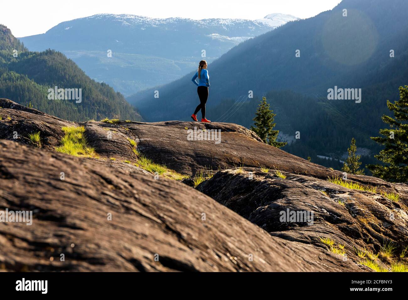 Sportswoman running on stones in highlands Stock Photo - Alamy