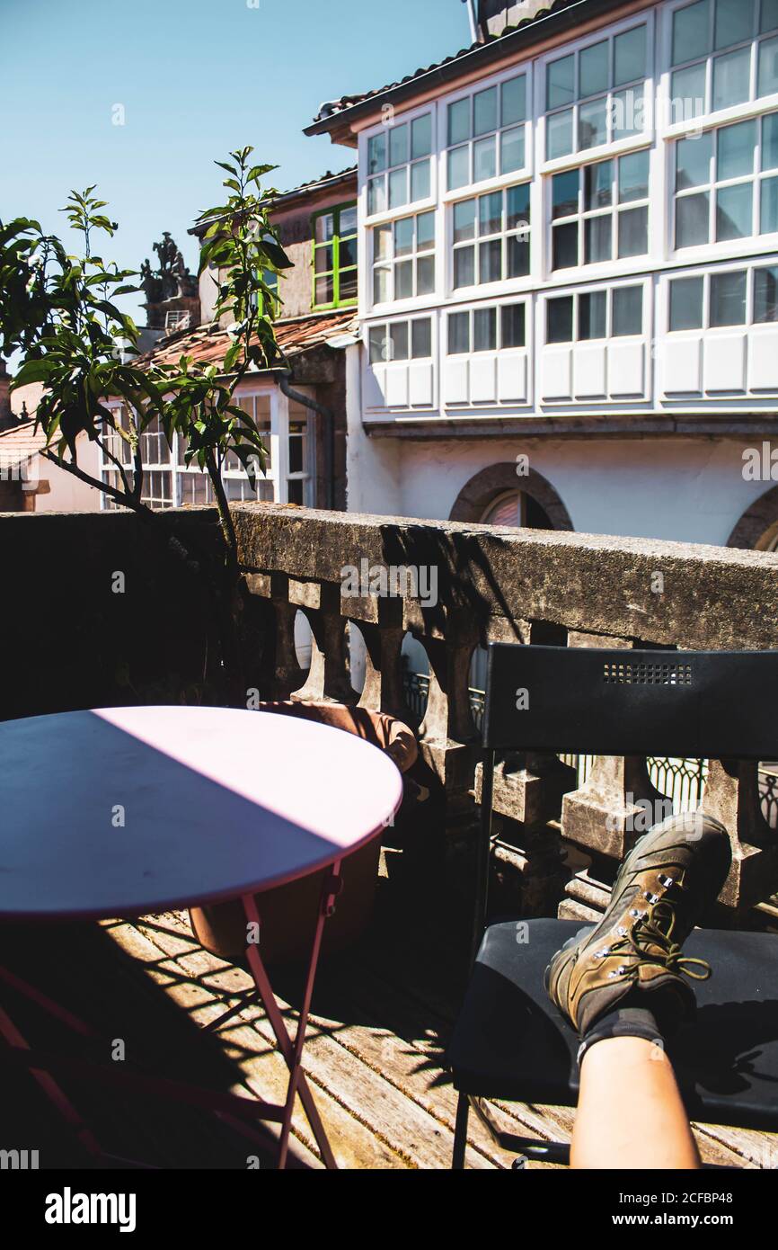 feet with boot on chair on a balcony Stock Photo - Alamy