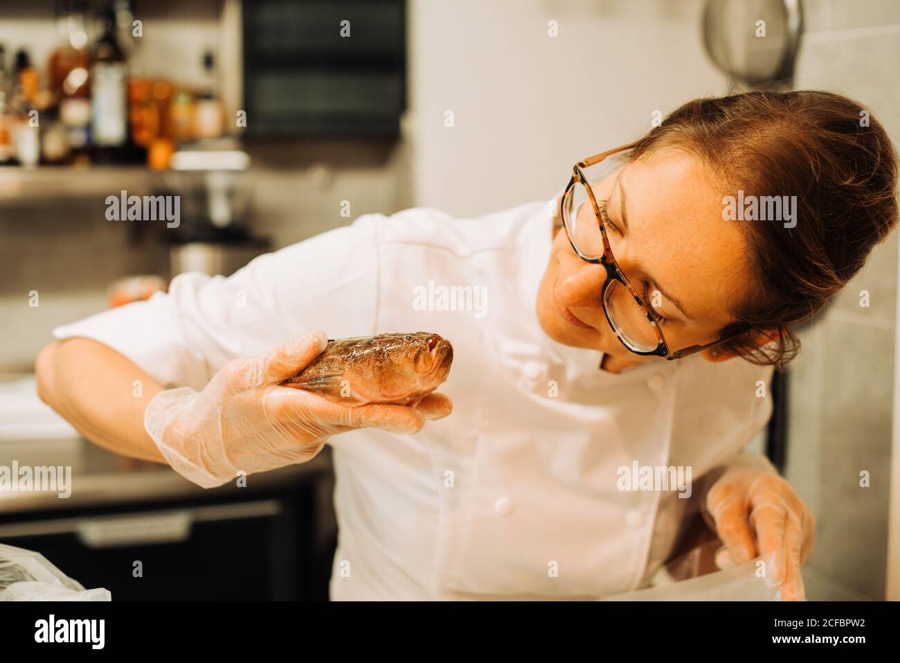 Female cooking fish hi-res stock photography and images - Alamy