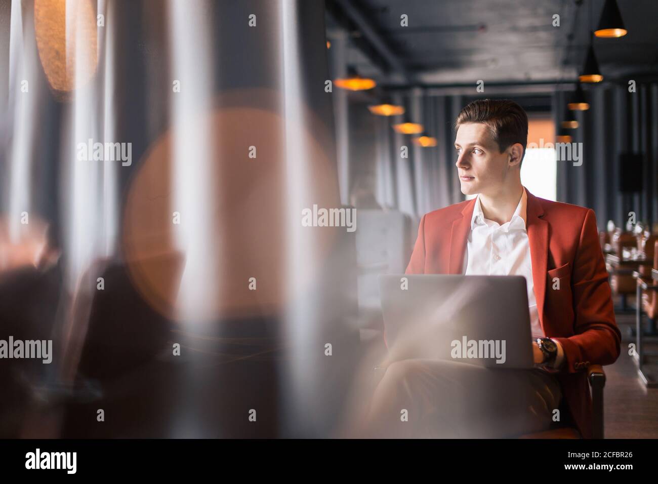Business owner of a coffee roastery checking his laptop Stock Photo - Alamy