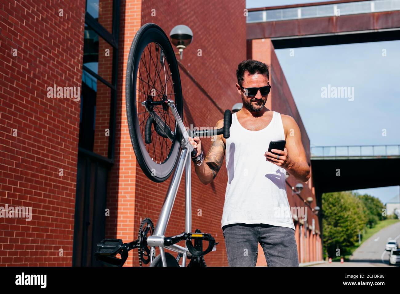 Man standing next to bike hi-res stock photography and images - Alamy