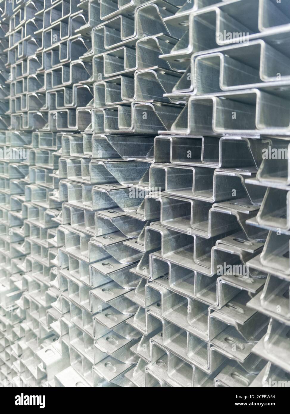 Full frame stack of bended zinc plated sheet metal parts - close-up ...