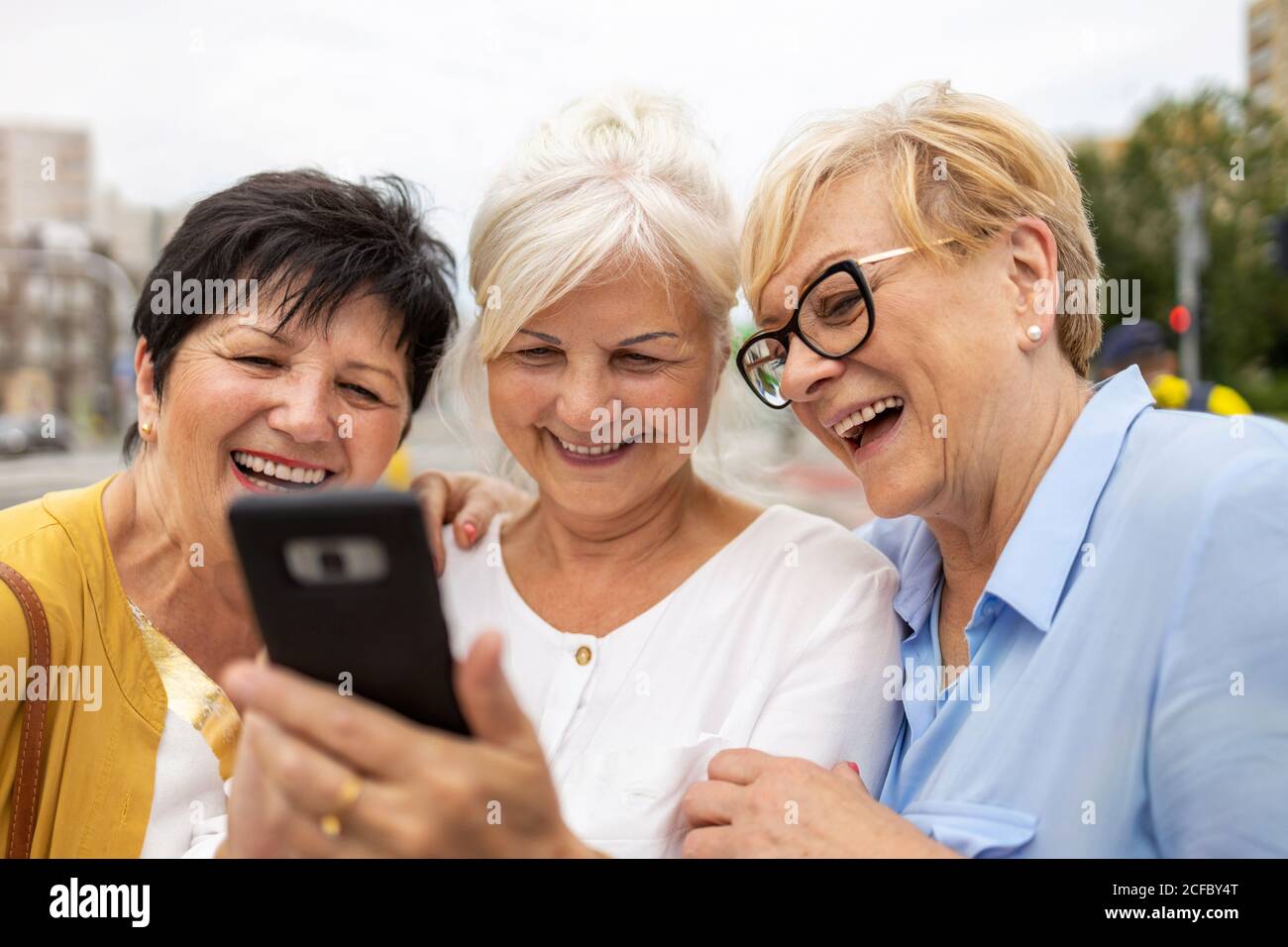 Group of senior women using smartphones together Stock Photo - Alamy