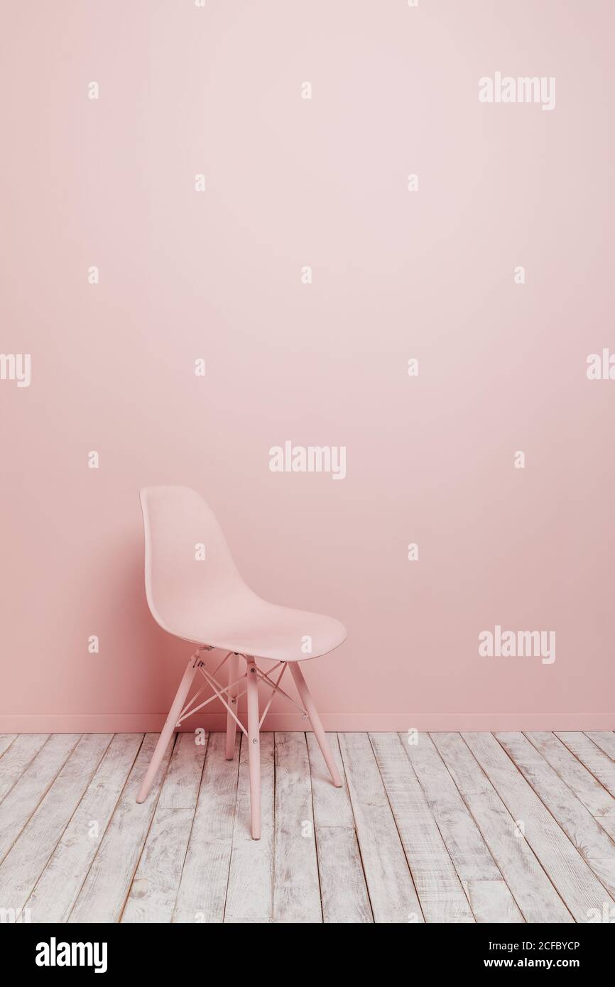 Side view of a single design pink chair on a pink background Stock ...
