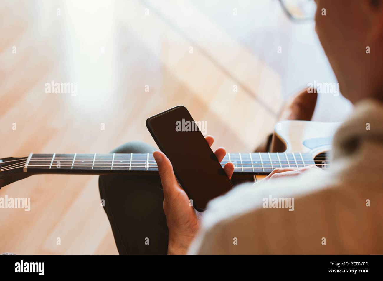 Musician looking at the mobile Stock Photo - Alamy