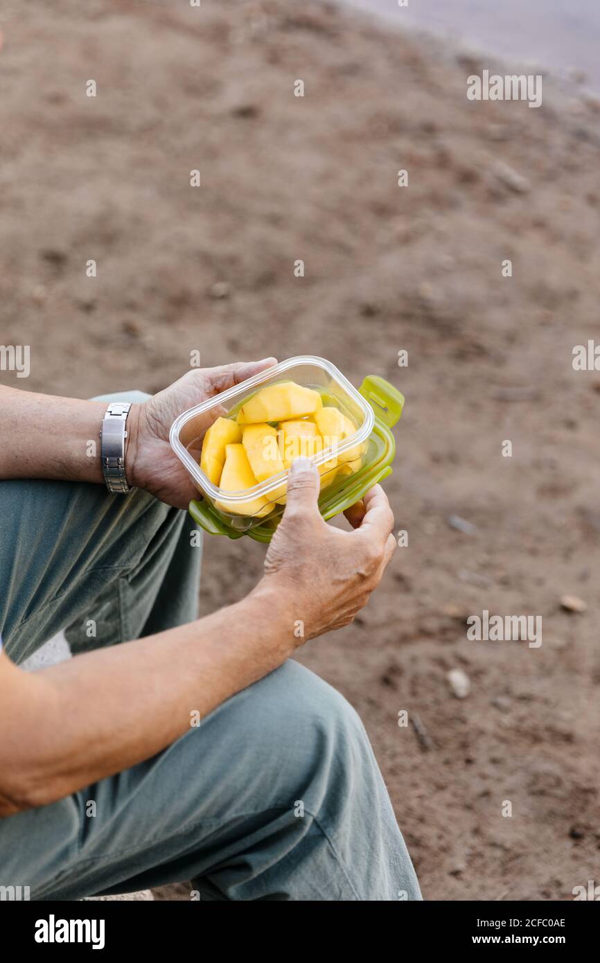 Detail of unrecognizable man eating mango fruit in the forest Stock ...
