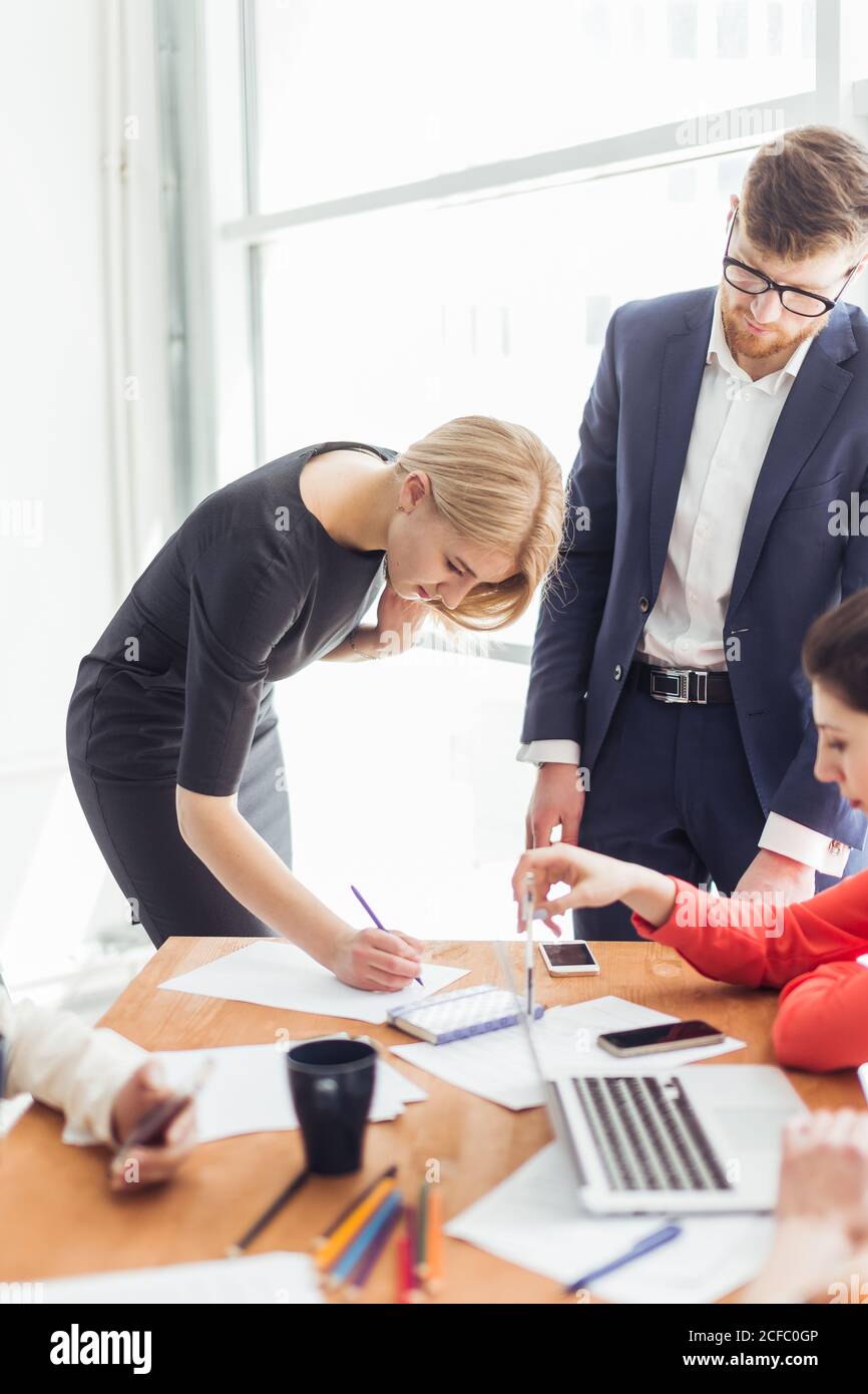Professional Woman Signing Document At Desk High Resolution Stock ...