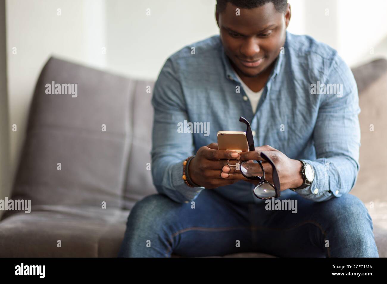 african american man using phone at his home Stock Photo - Alamy