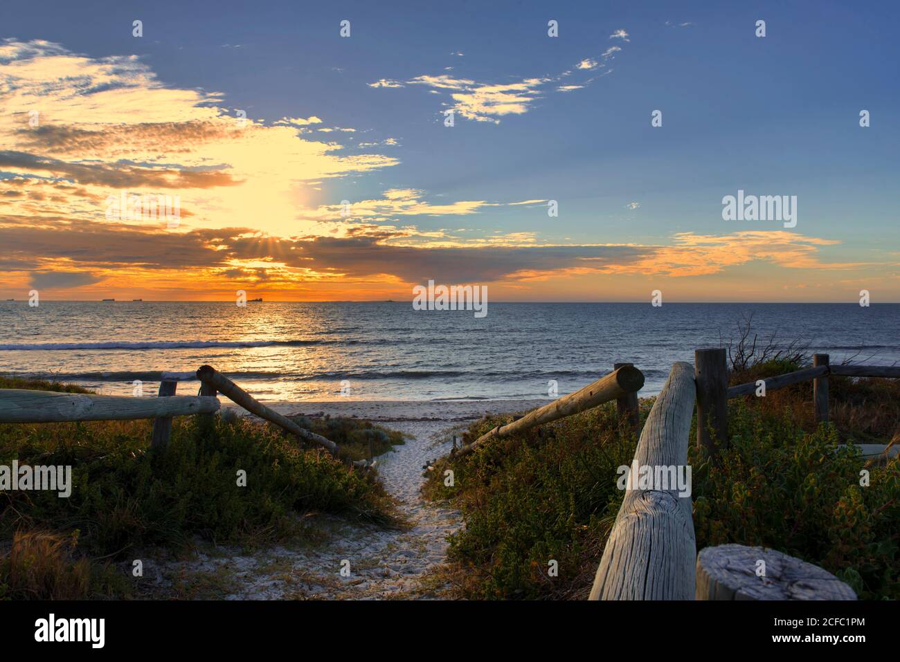 Sunset over Indian Ocean with sandy beach and shrubs, Western Australia ...