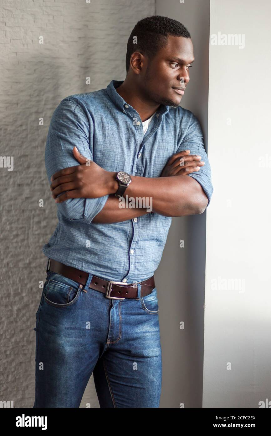 African leaned against the wall in his house Stock Photo - Alamy
