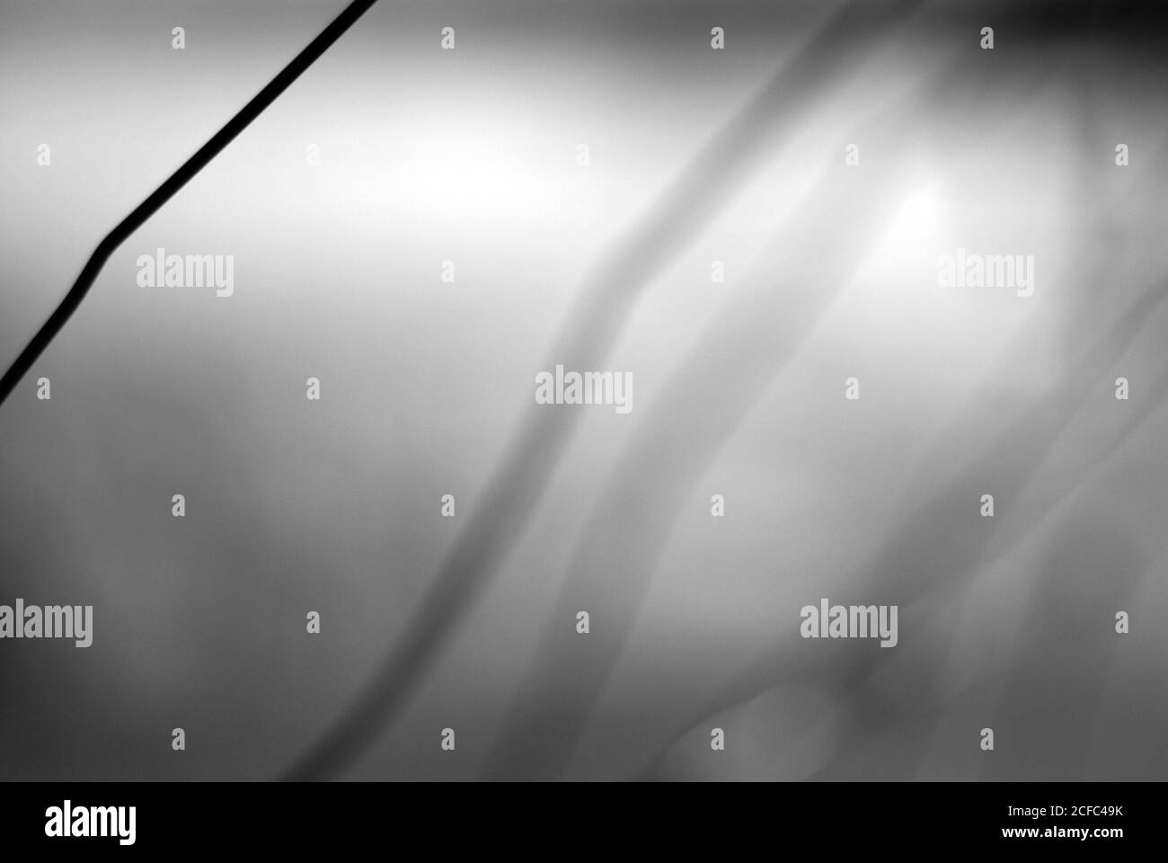 Closeup of shiny strained metal barbed wire on blurred background in ...