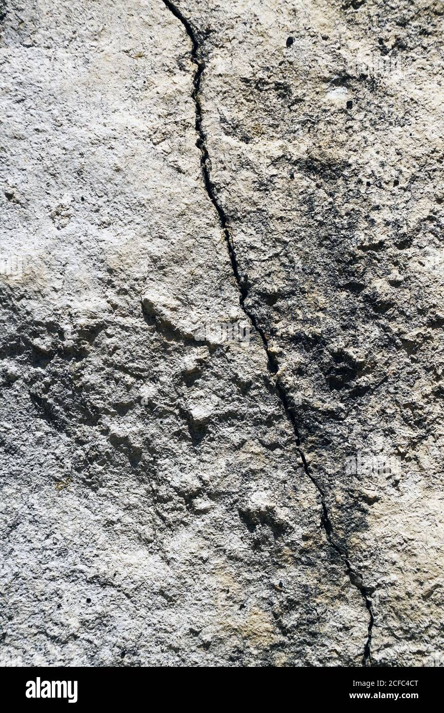 abstract background of shabby rough geological crevice in rocky surface ...