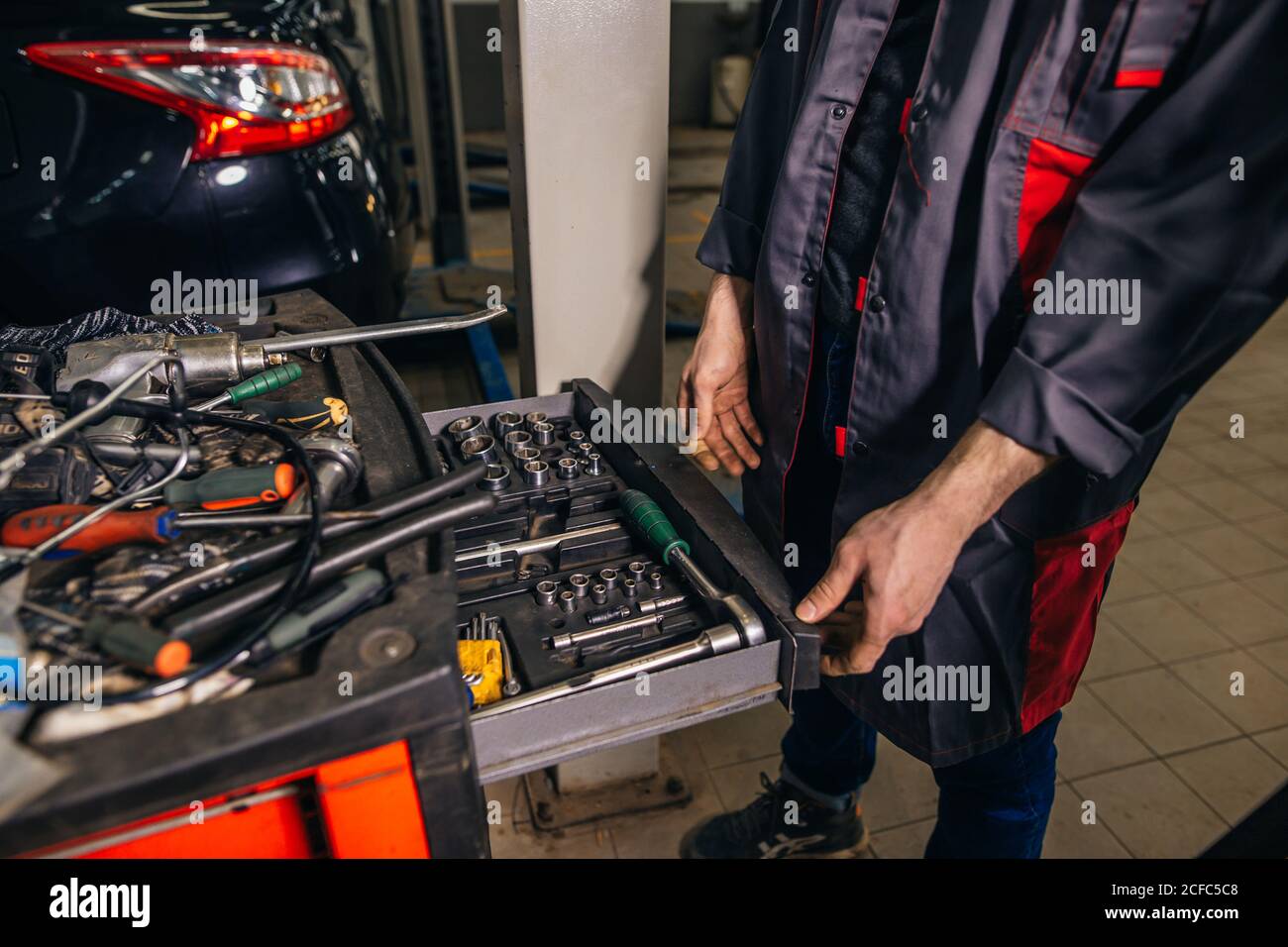 male Mechanic taking facilities from special box for mechanical ...