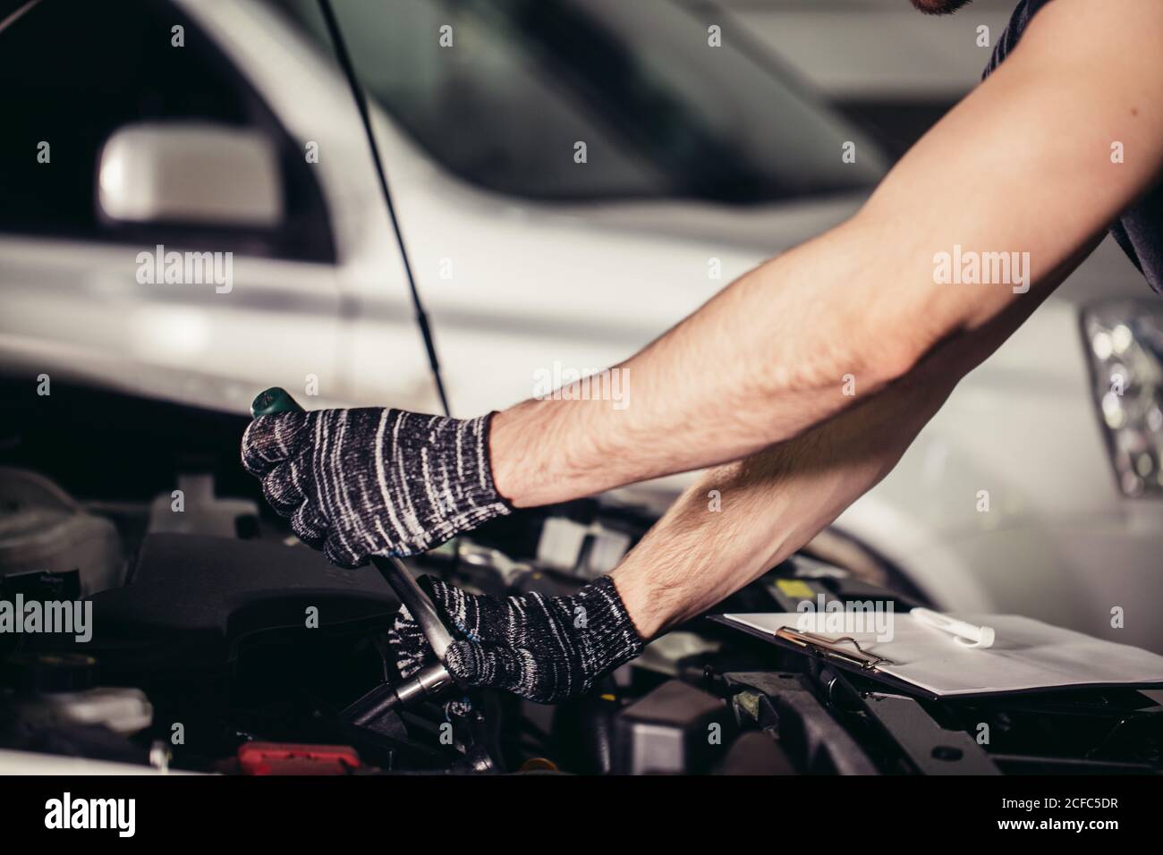 car mechanic his repair shop standing near car. close-up engine Stock ...