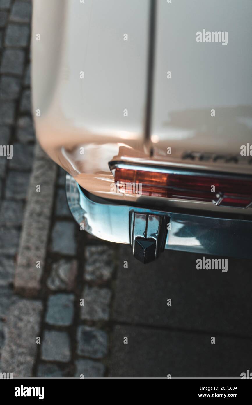 From above back view of part of old stylish car parked on pavement ...