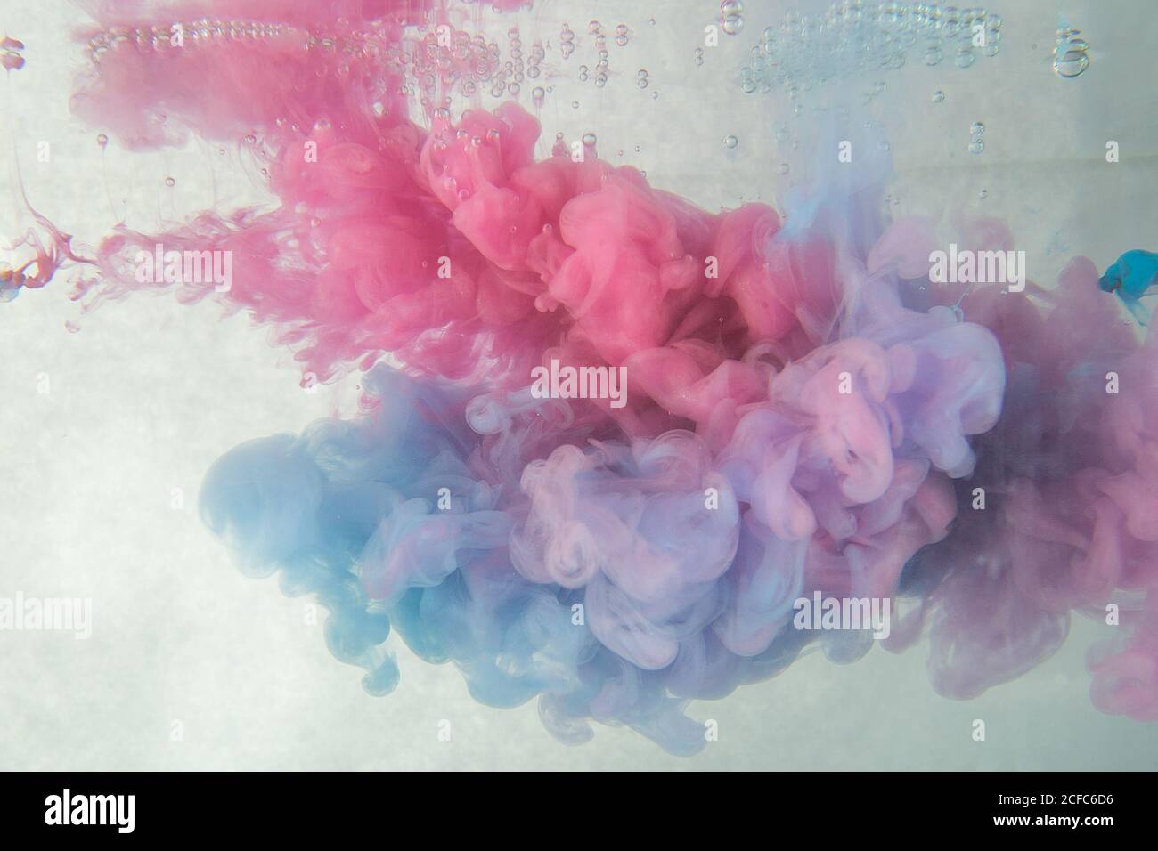 Abstract red and blue paint splash in water Stock Photo - Alamy