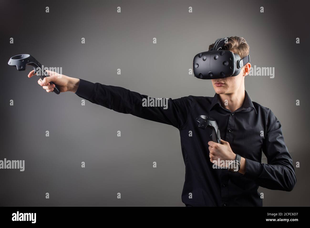 Virtual Reality headset on a man with video game controller Stock Photo ...