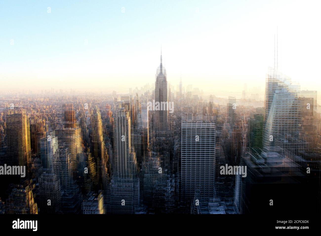 Blurry cityscape of sun rising in blue morning sky above famous ...