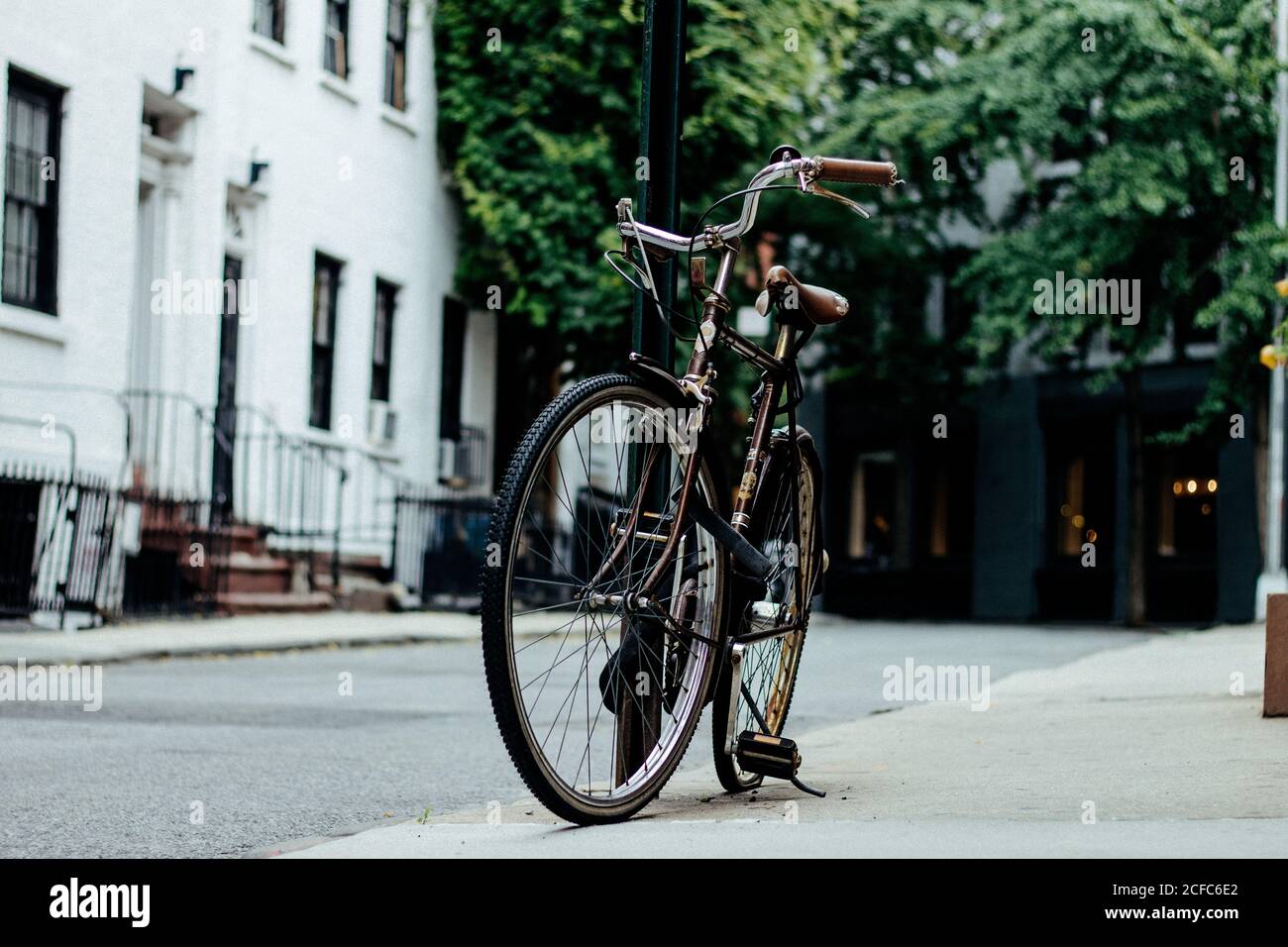 Low angle of bicycle standing on deserted suburb street of New York ...
