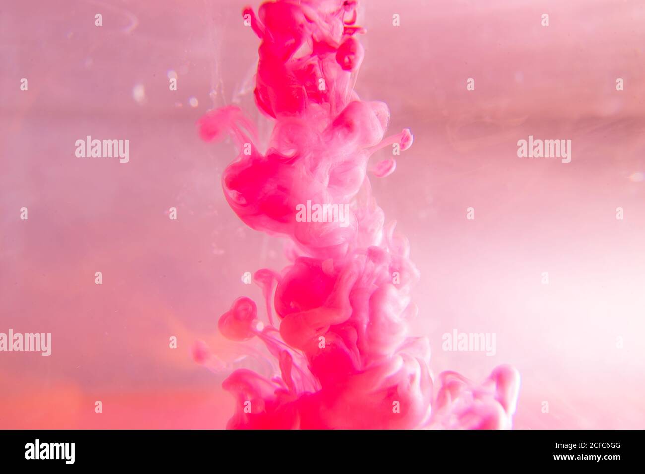 Abstract paint pink splash drip up in water Stock Photo - Alamy