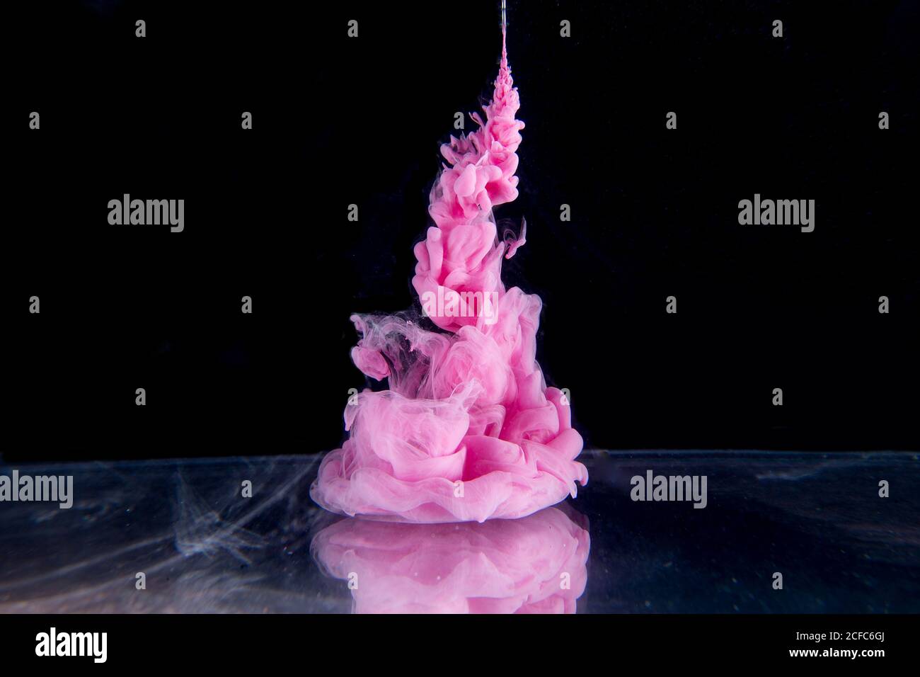 Abstract paint pink splash drip up in water Stock Photo - Alamy