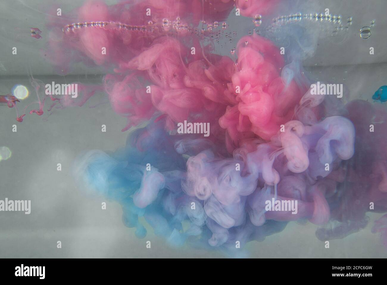 Abstract red and blue paint splash in water Stock Photo - Alamy