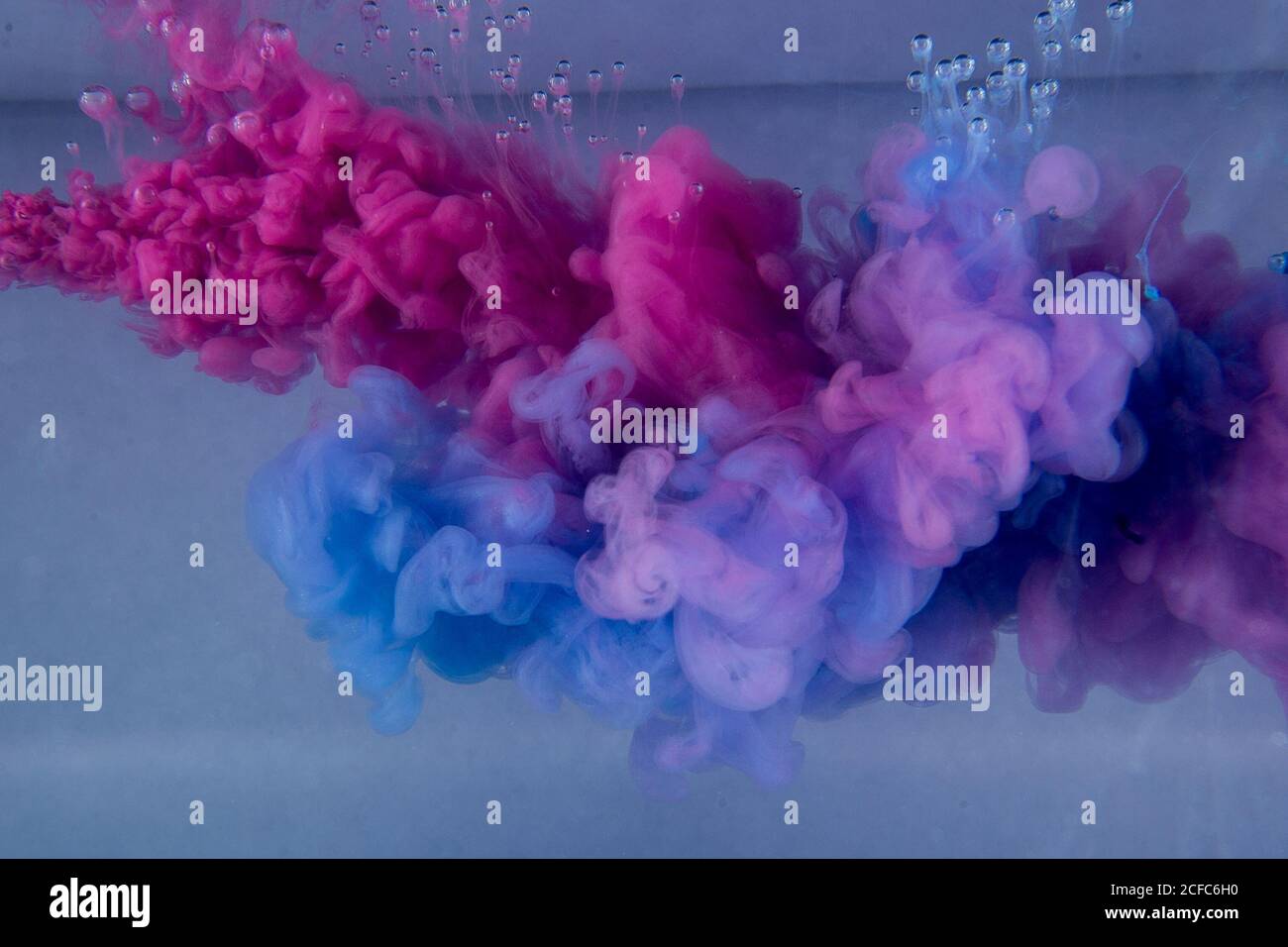Abstract red and blue paint splash in water Stock Photo - Alamy