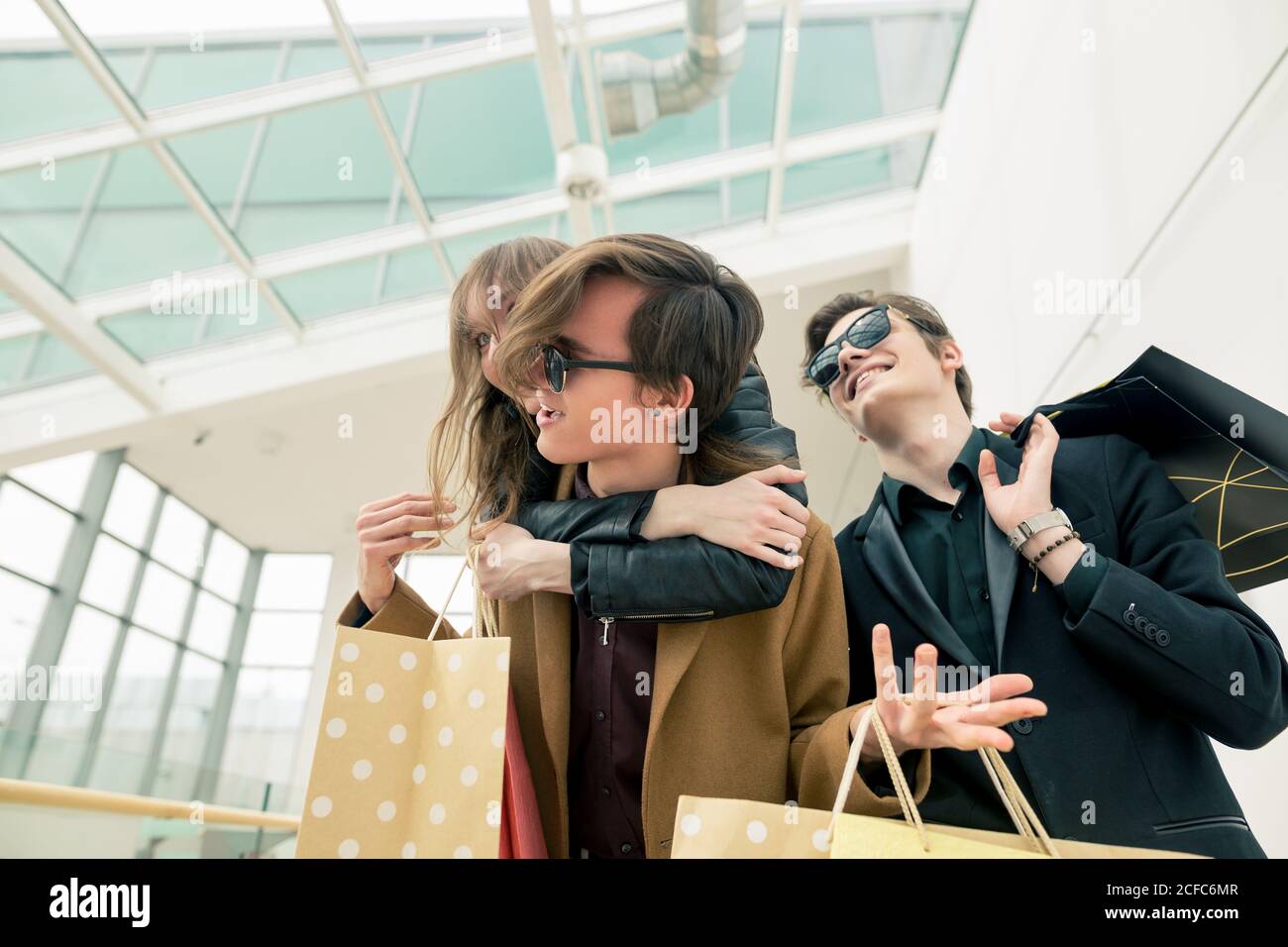 Young friends having fun on shopping mall Stock Photo - Alamy