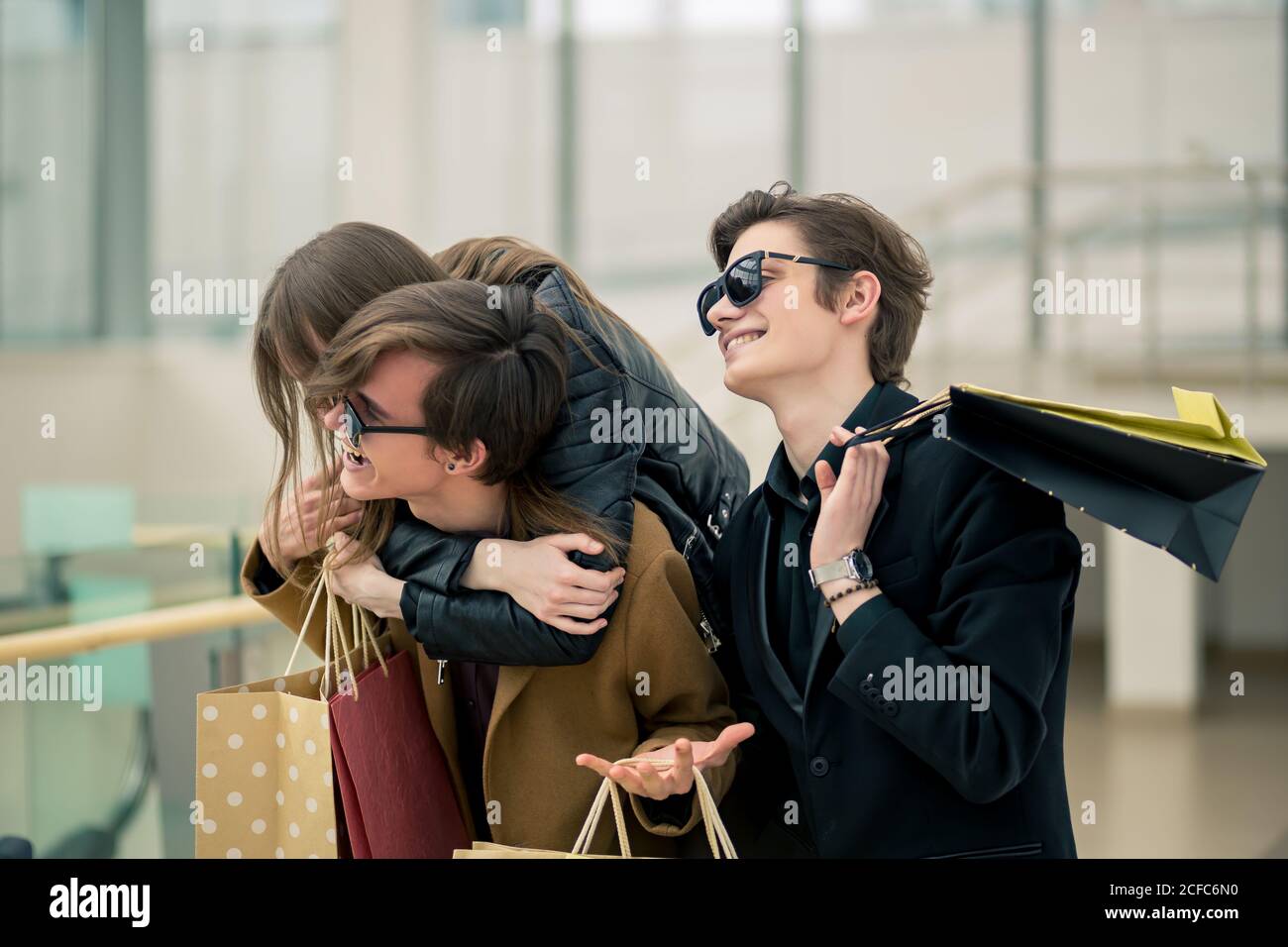 Young friends having fun on shopping mall Stock Photo - Alamy