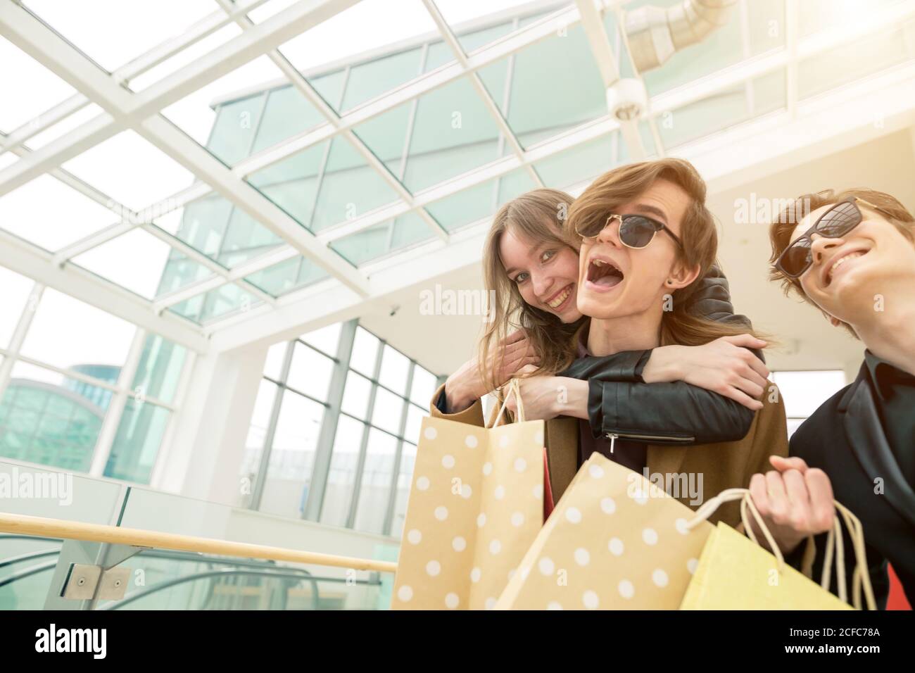Young friends having fun on shopping mall Stock Photo - Alamy