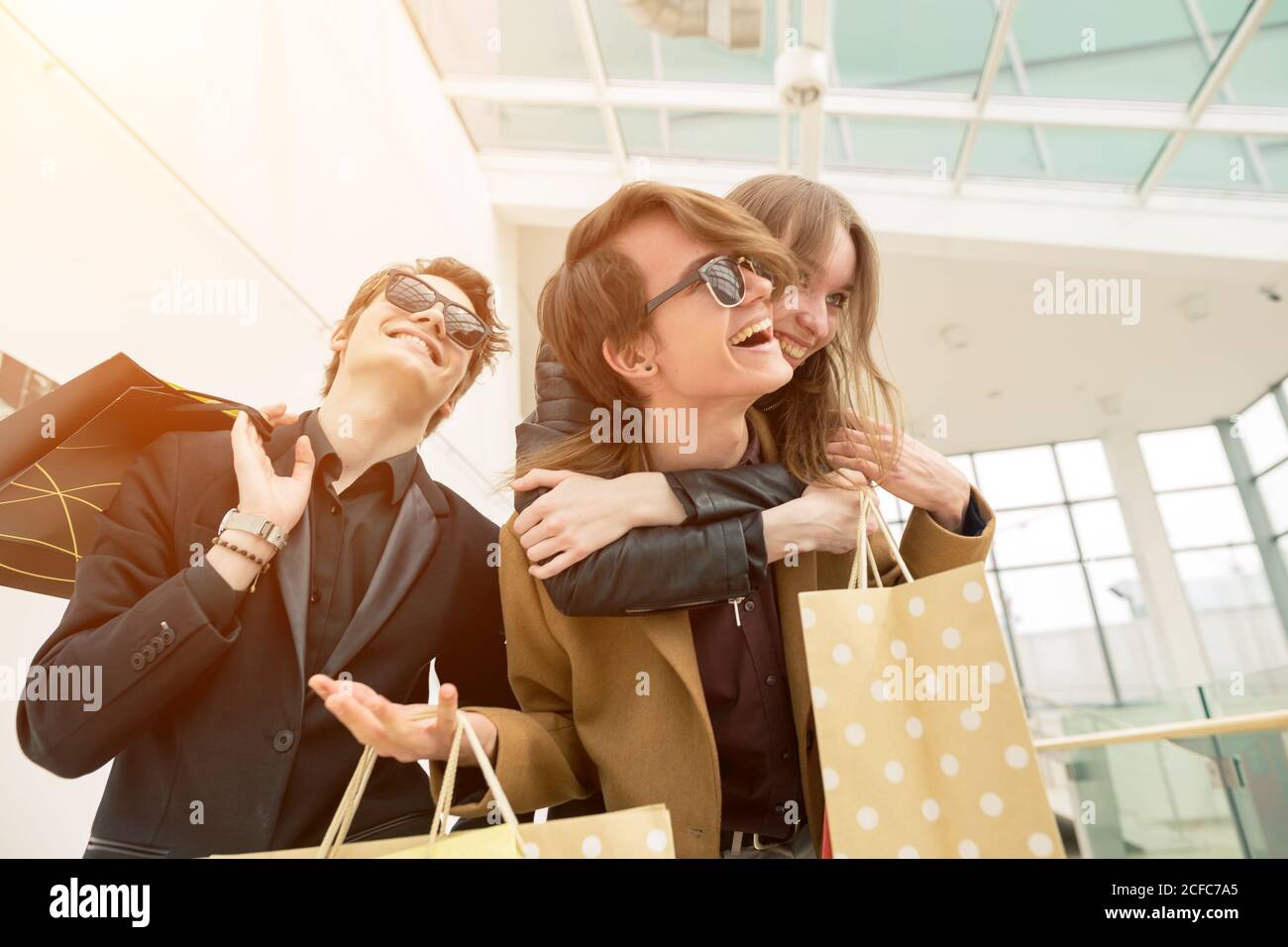 Young friends having fun on shopping mall Stock Photo - Alamy