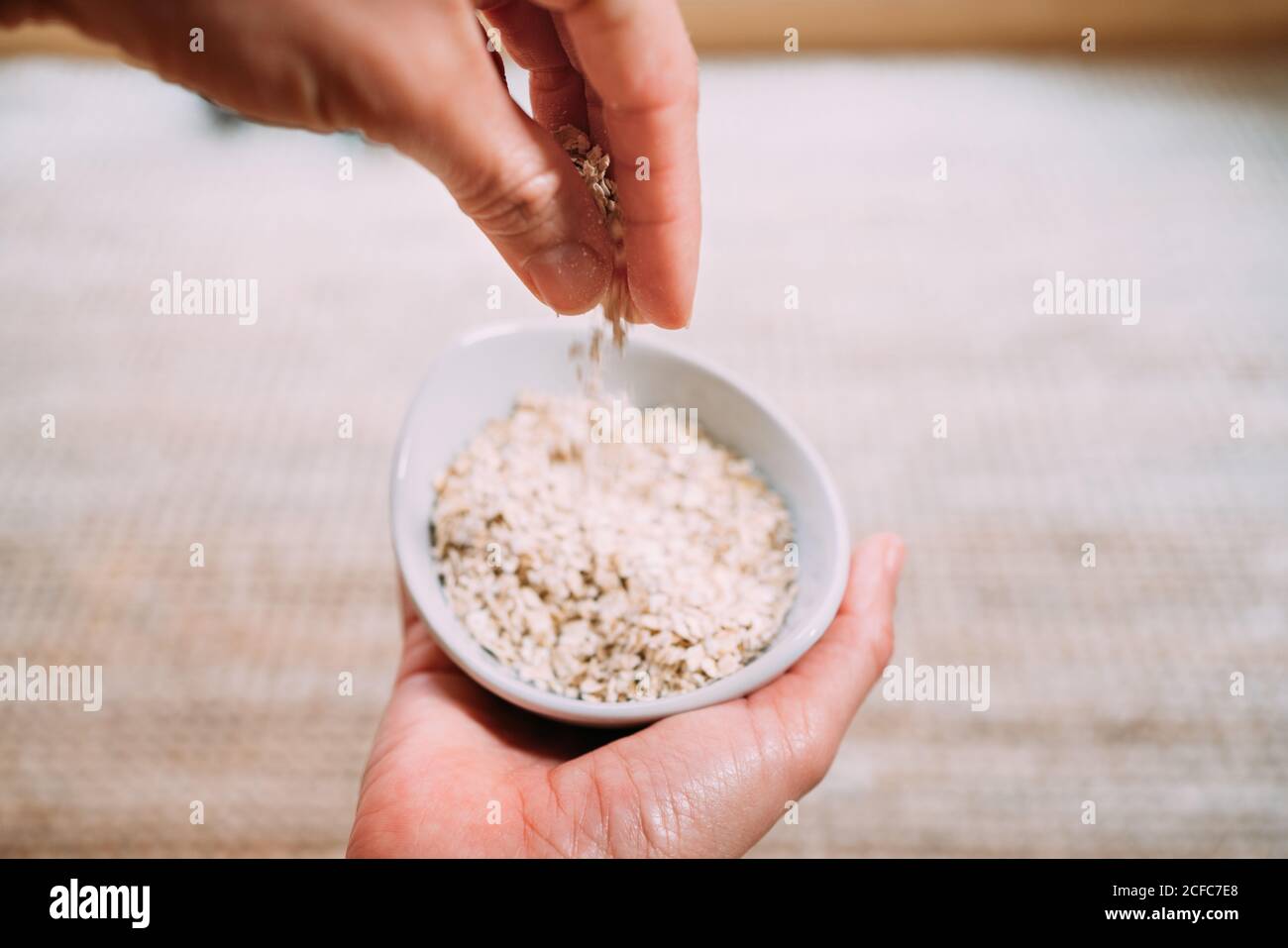 Hand pouring white sesame hi-res stock photography and images - Alamy