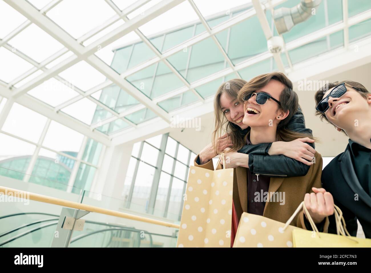 Young friends having fun on shopping mall Stock Photo - Alamy