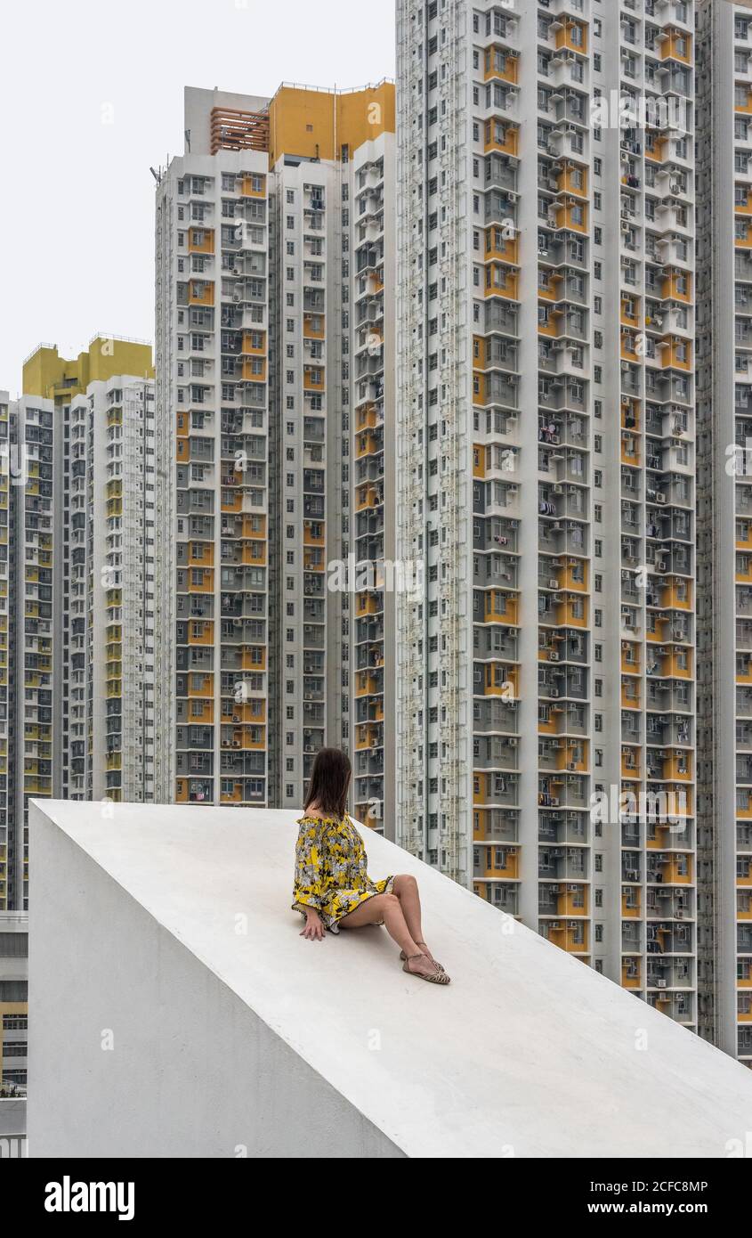 Unrecognizable male in hat opening chopper with dried ground hemp ...